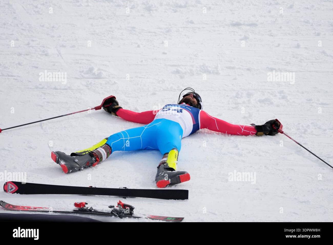 Luxembourg's Matthieu Osch lies on the snow at the finish area, during ...