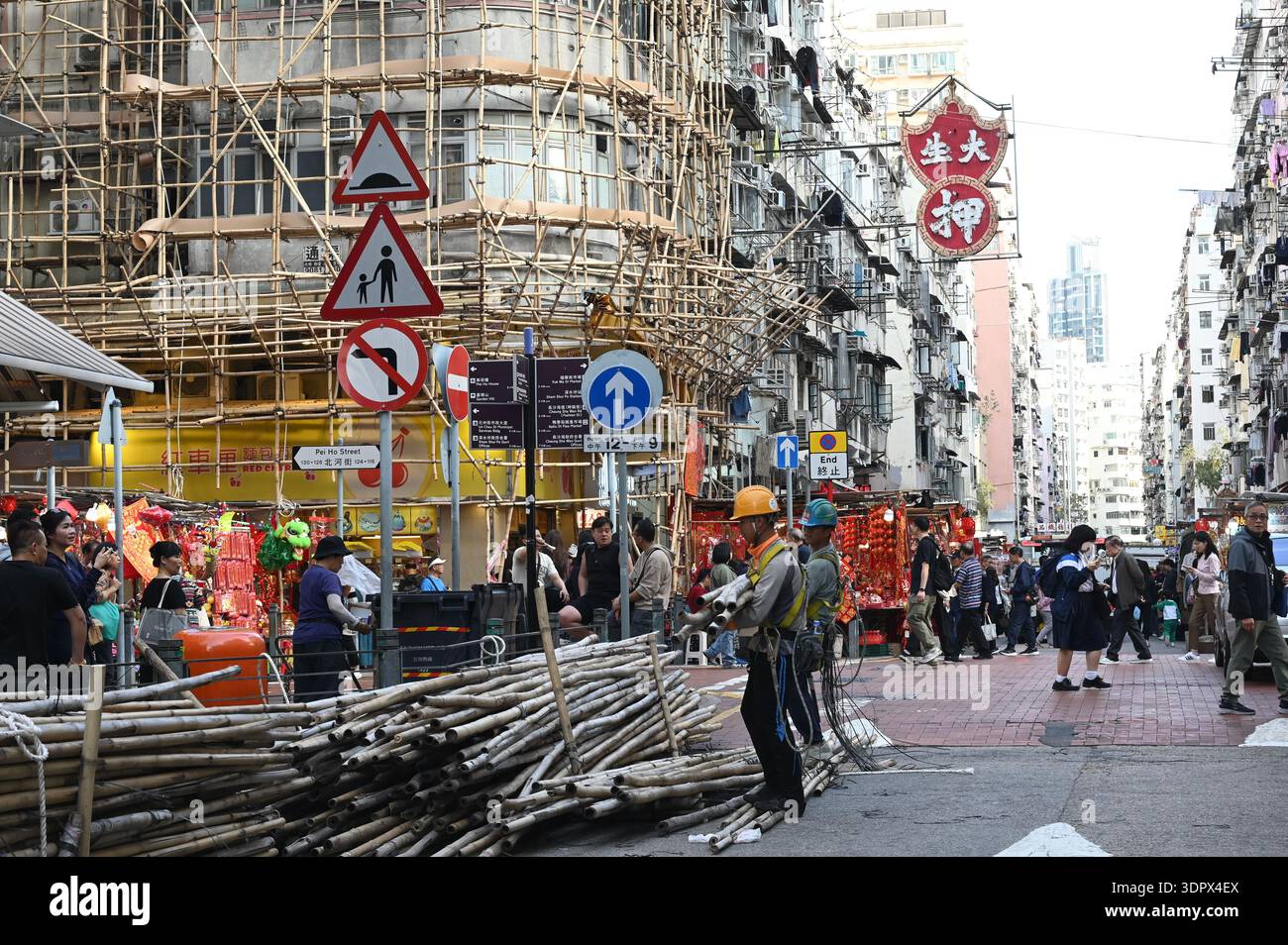 Two workers setting bamboo scaffolding of building at Sham Shui Po on ...
