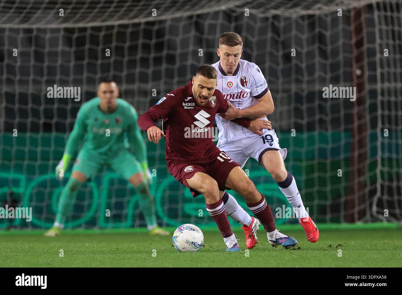 Turin, Italy, 15th February 2026. Lewis Ferguson of Bologna FC tussles ...