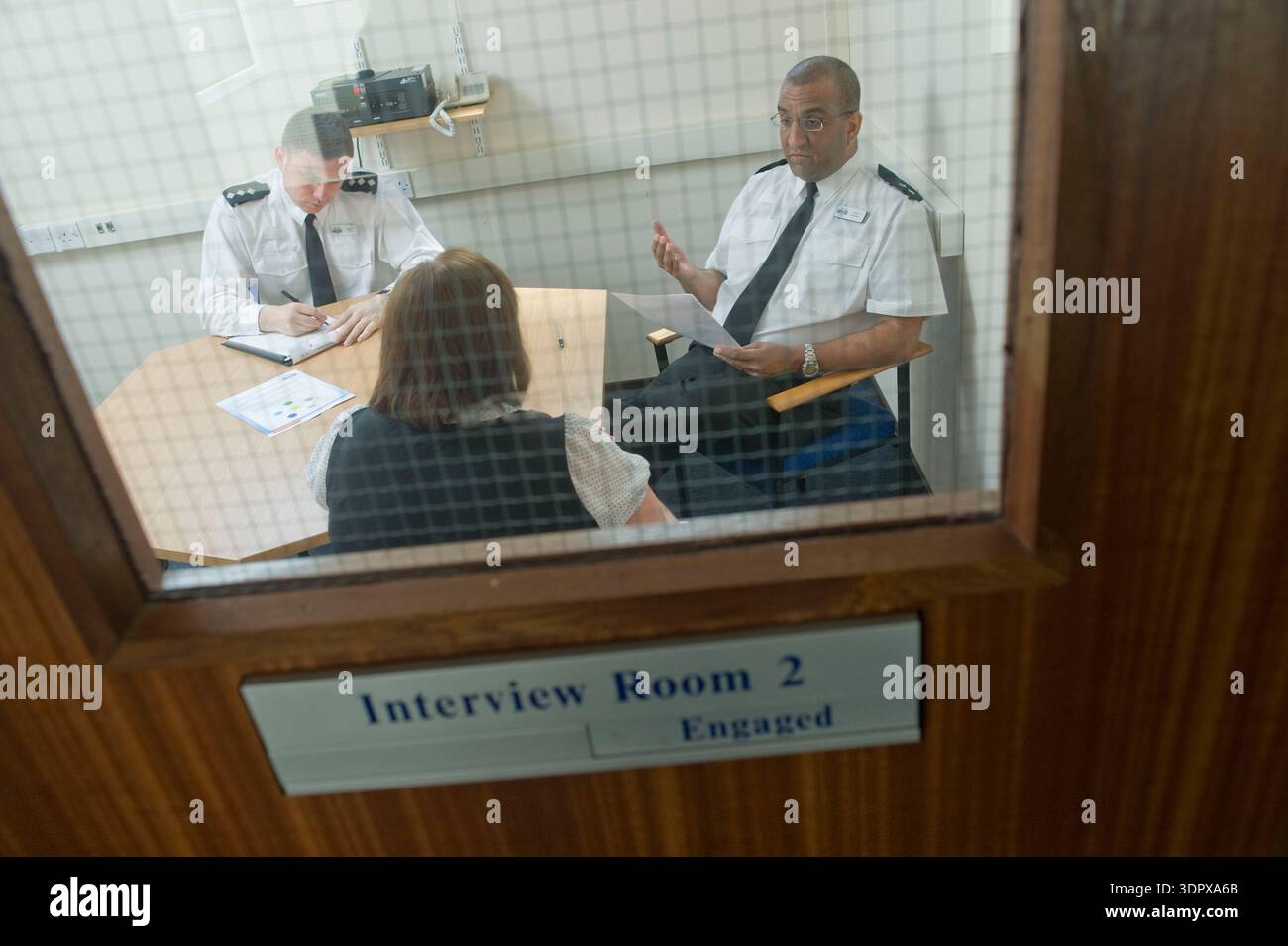 Police officers interviewing a suspect - played by a model Stock Photo ...