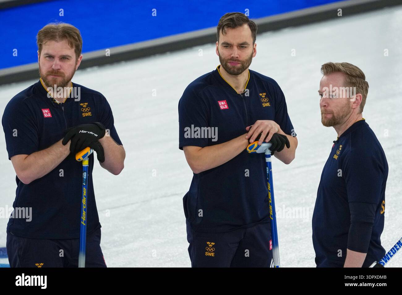 Sweden's Niklas Edin, Oskar Eriksson, and Rasmus Wranaa look on during ...