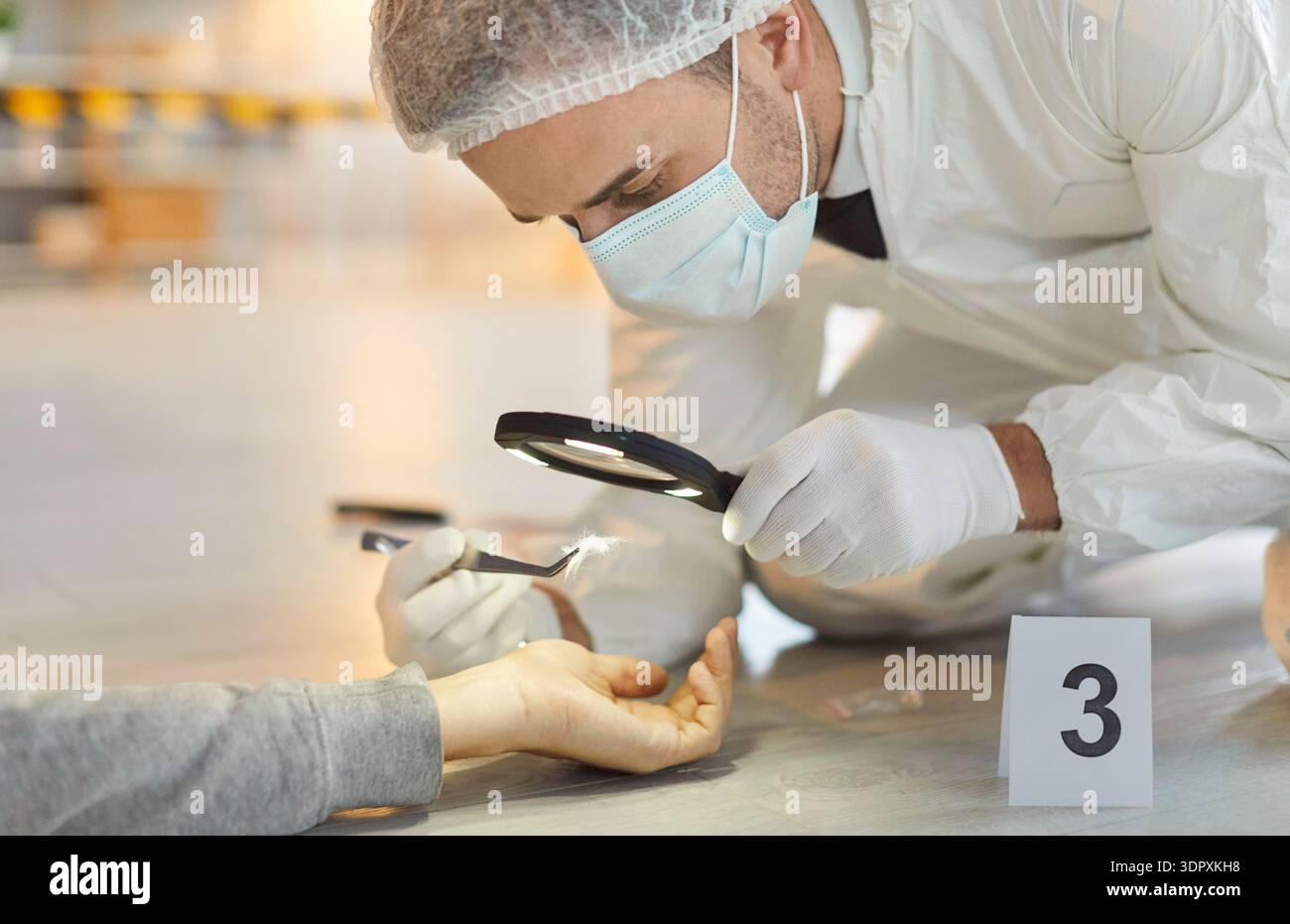Forensic expert examining corpse hand with magnifying glass collecting ...