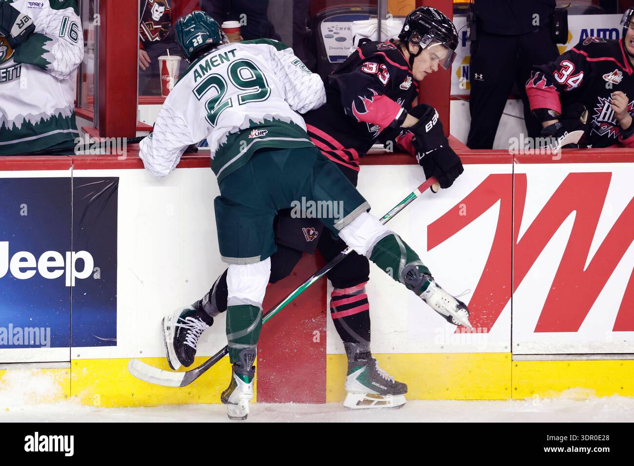 Everett Silvertips C Henri Ament, lt, hits Calgary Hitmen D Jakub Seidl ...