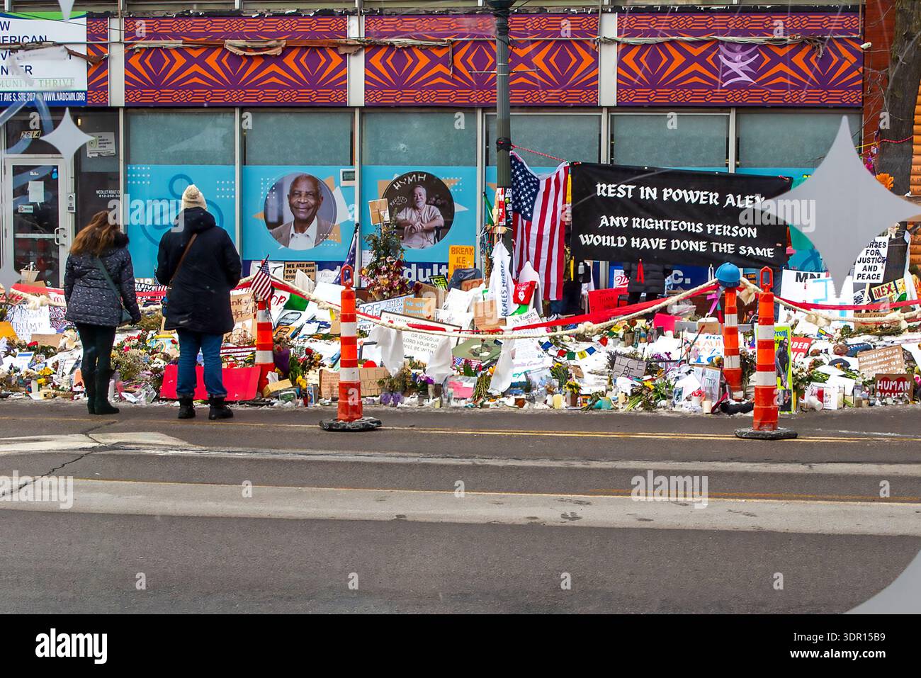Two people at the memorial to Alex Pretti who was shot and killed by ...