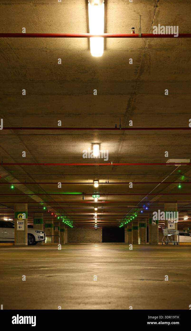 Vertical view of underground parking garage interior with green ...