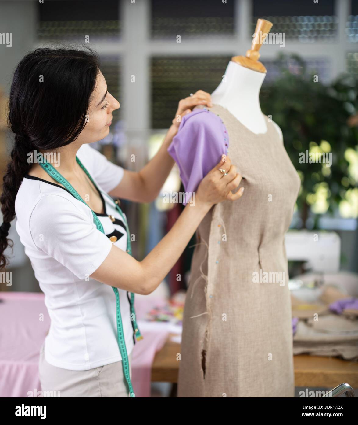Seamstress shaping dress on mannequin in tailoring studio Stock Photo ...