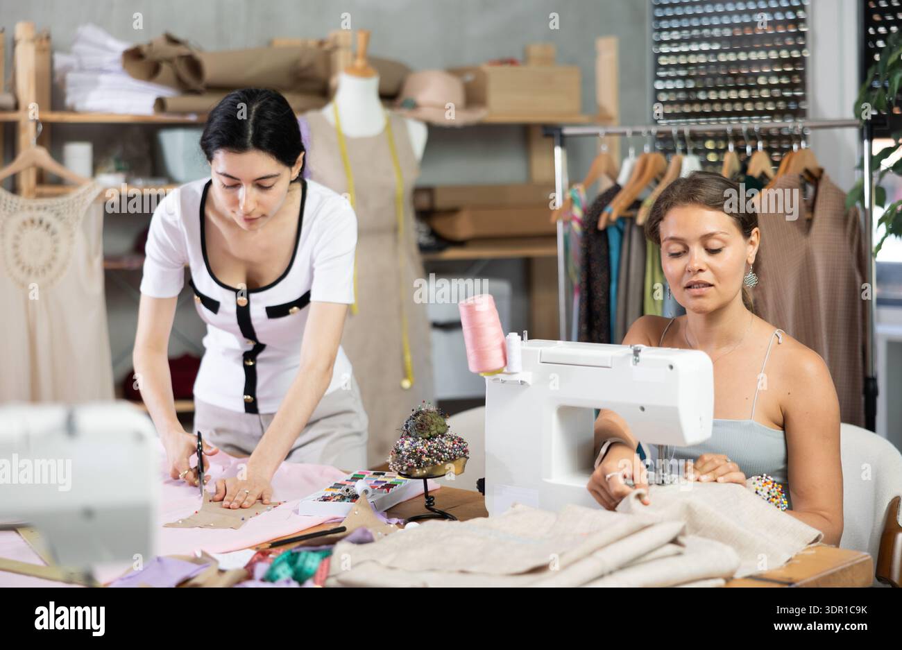 Two female tailors creating custom garments in workshop Stock Photo - Alamy