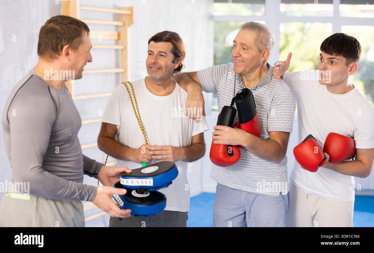 Group of men talking after training in studio Stock Photo - Alamy