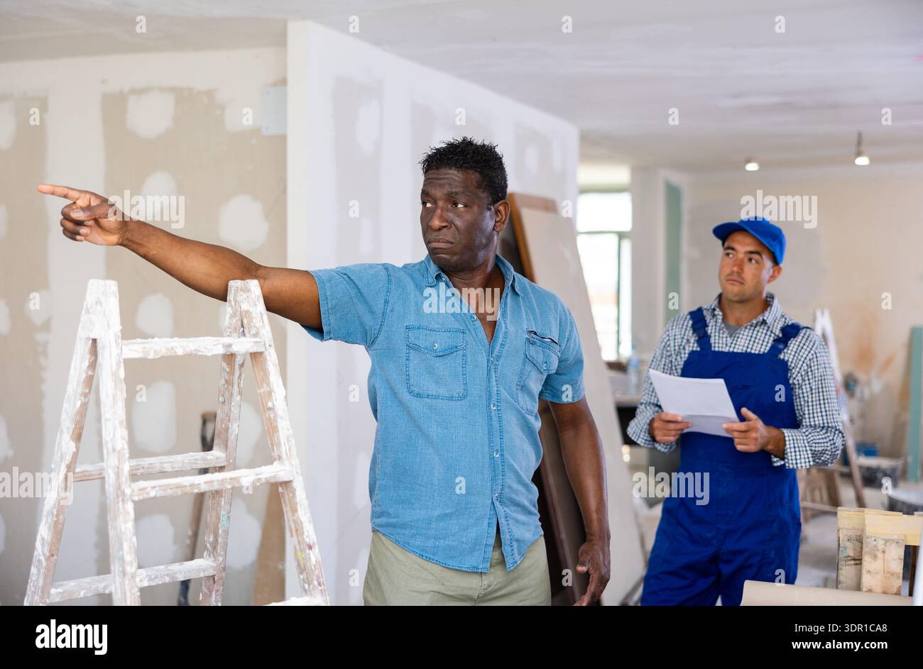 Disappointed owner of apartment showing problem to repairman Stock ...
