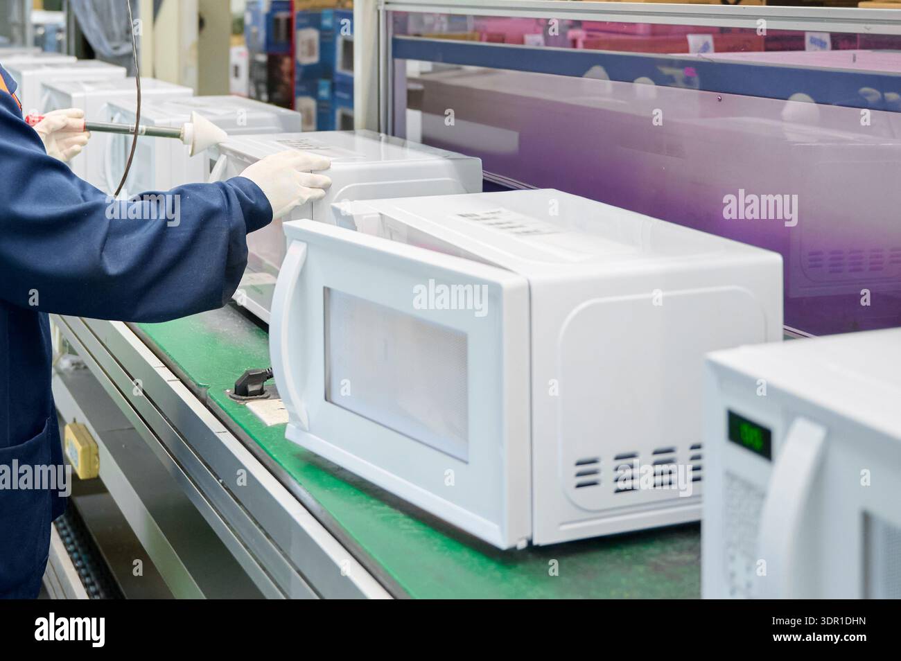 Engineer conducts microwave leakage testing on production line for ...