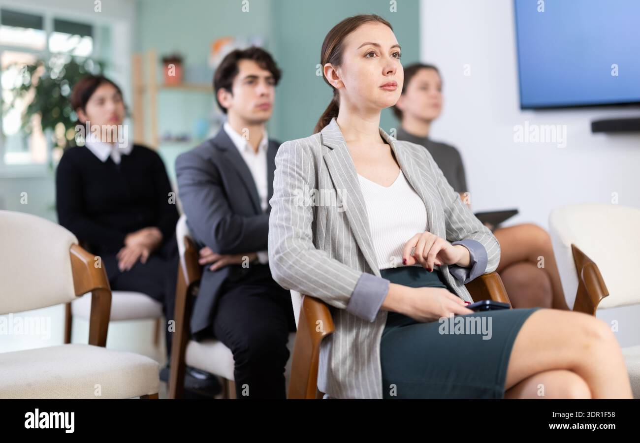 Young woman listens to presentation in conference room Stock Photo - Alamy