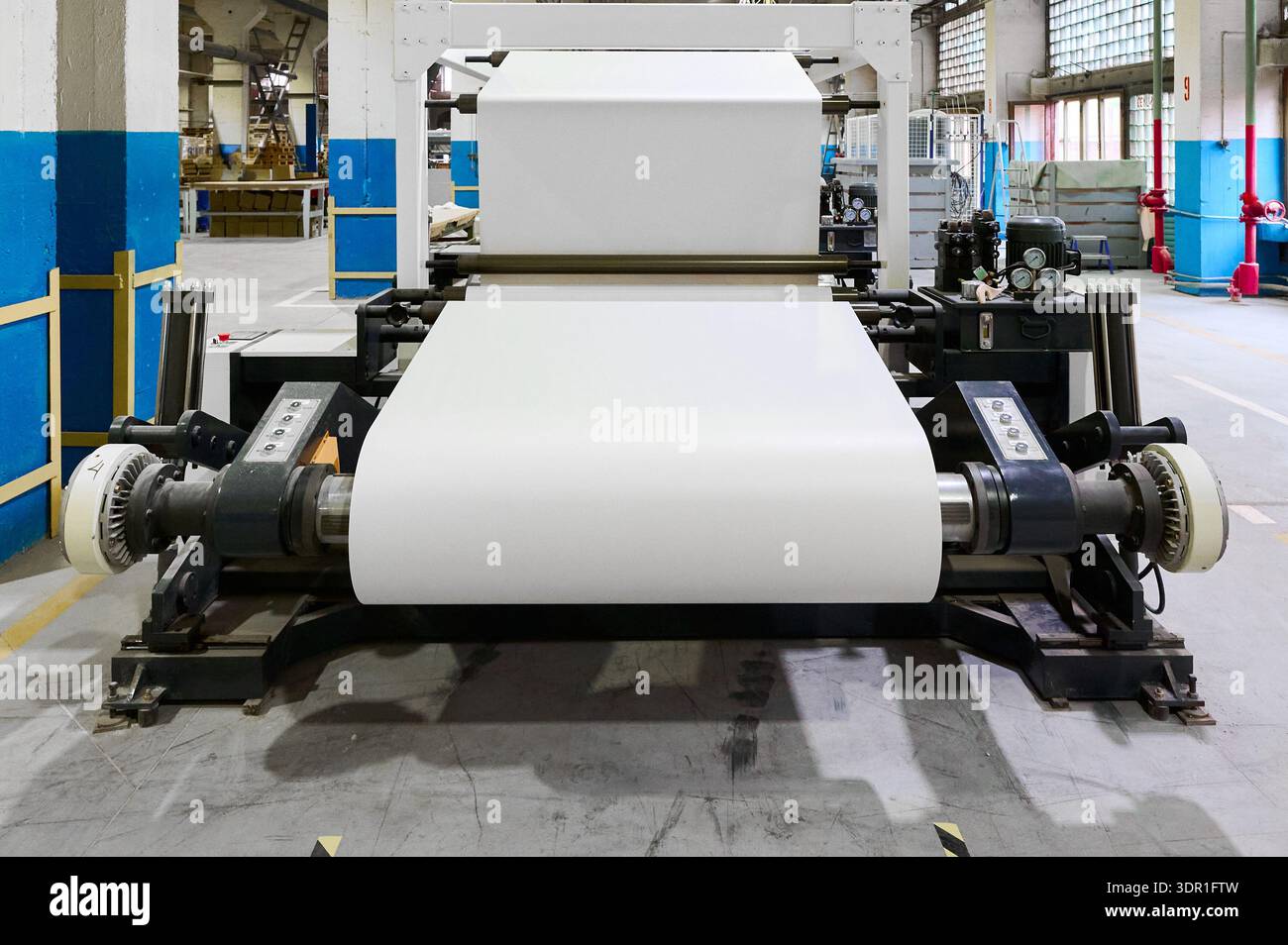 Large paper roll machine operating in an industrial factory during ...