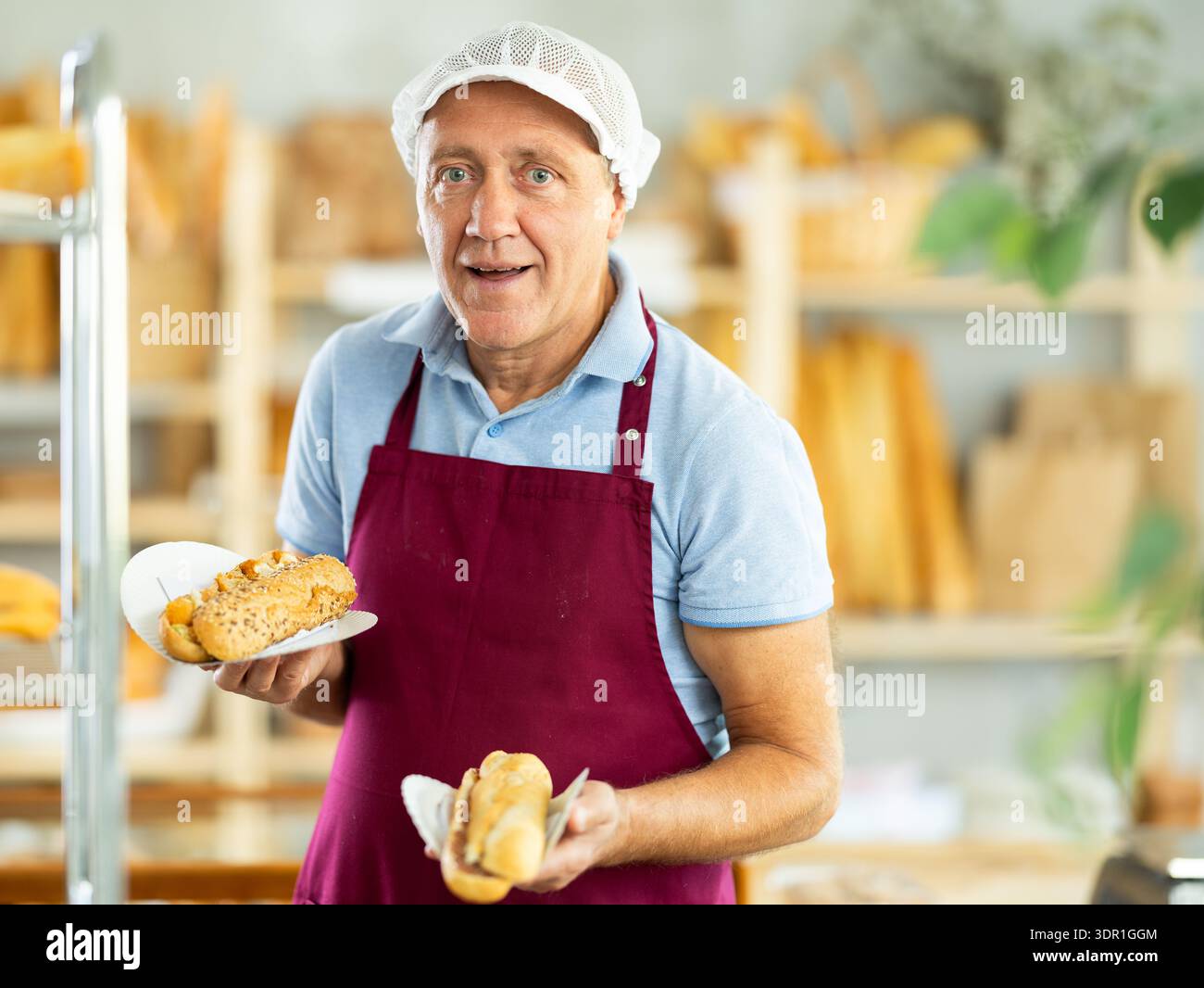 Elderly man chef of pastry shop demonstrates product of assortment ...