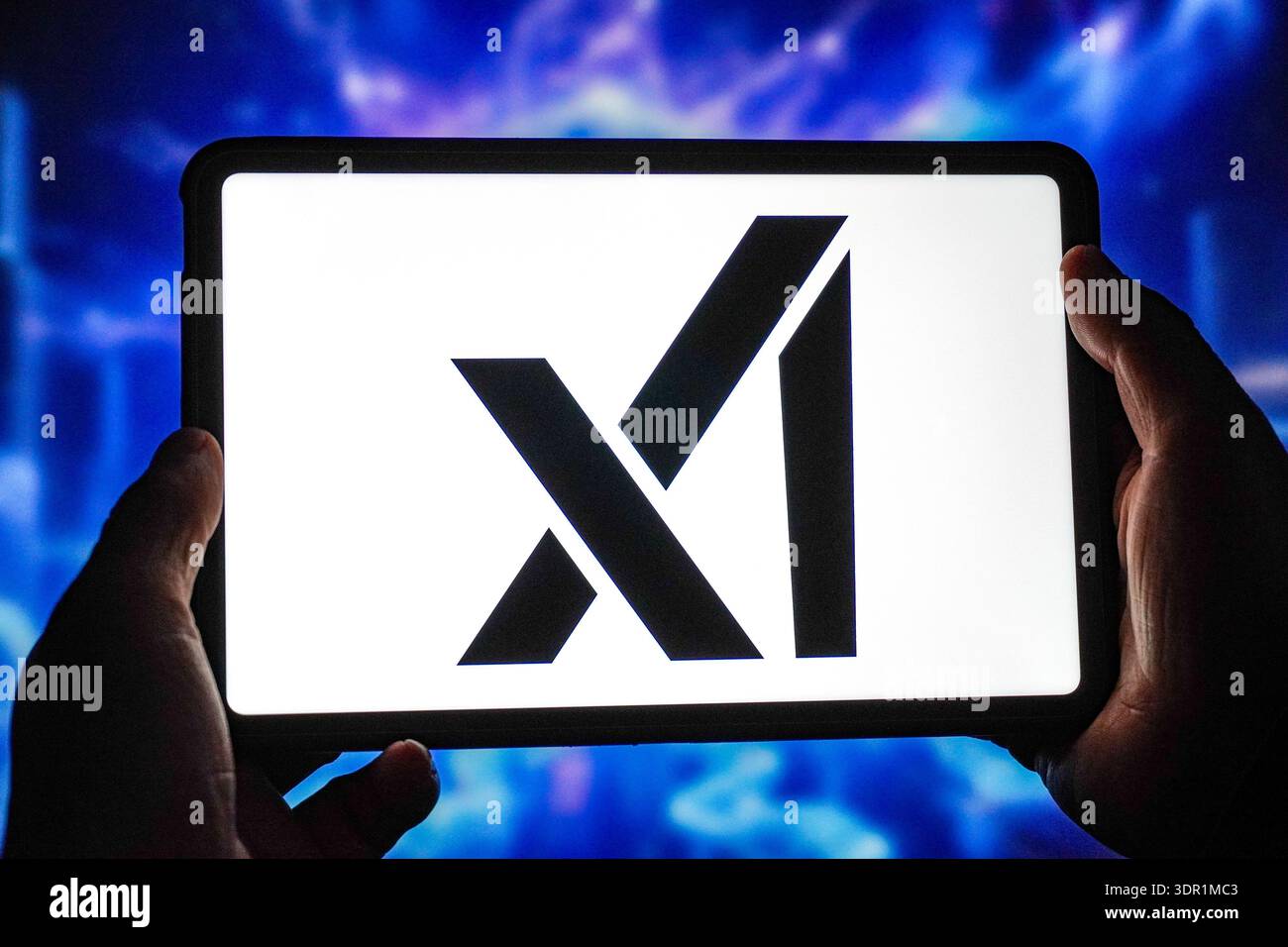 In this photo illustration, the xAI logo is displayed on the screen of ...