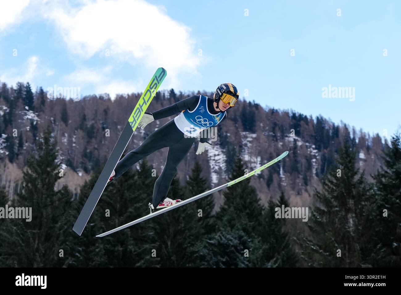 Zhao Zihe, of China, soars through the air during his trial jump of the ...