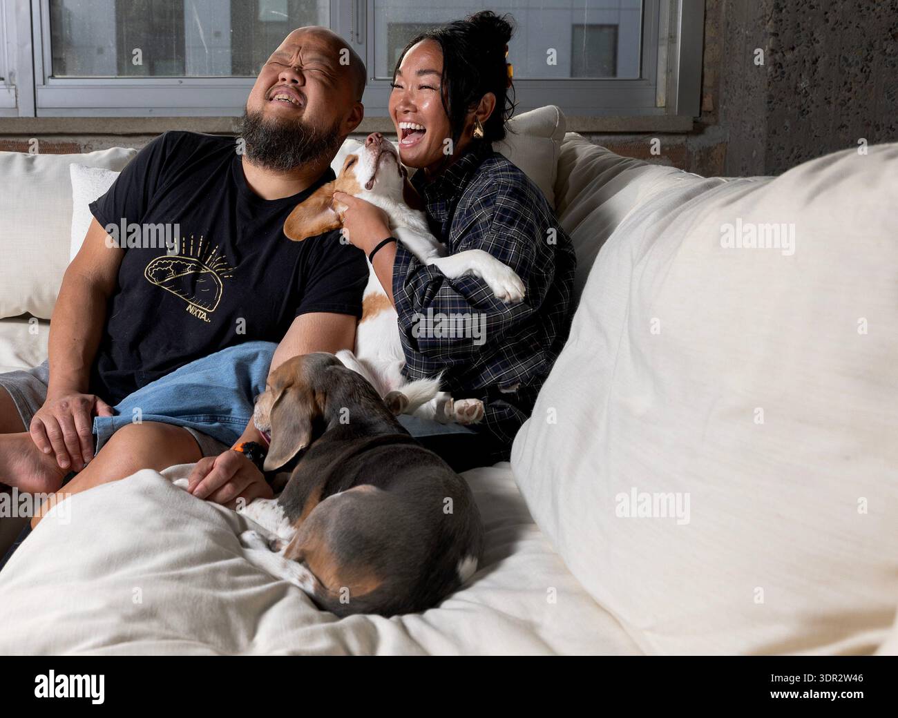 Yia Vang and Amanda Burke photographed with their two dogs, Charlie and ...
