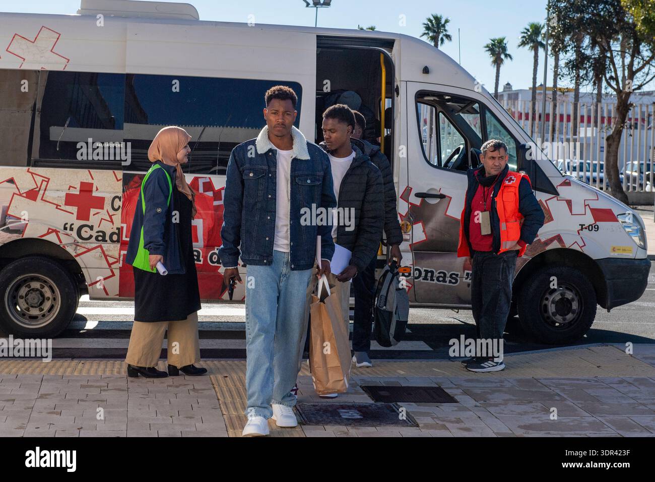 Several people leaving the Temporary Stay Centre for Immigrants (CETI ...