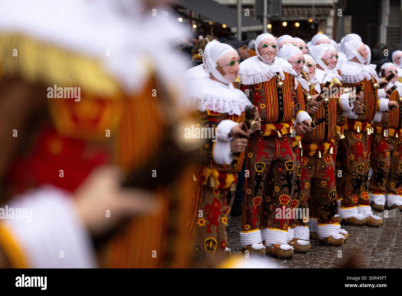 The Gilles of Binche wear their traditional wax masks as they attend ...