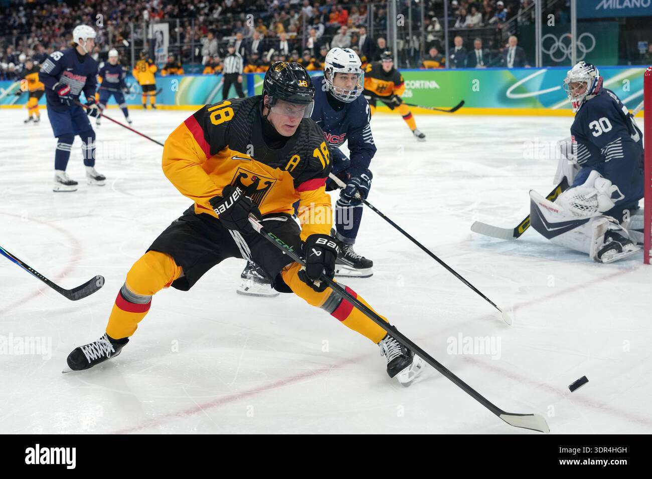Germany's Tim Stutzle (18) chases the puck ahead of France's Jules ...