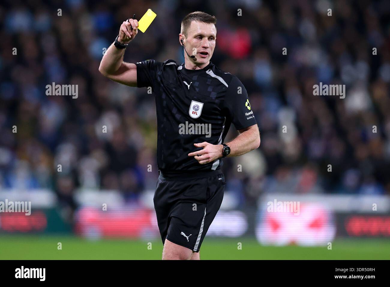 Referee Thomas Bramall shows a yellow card during the Coventry City v ...