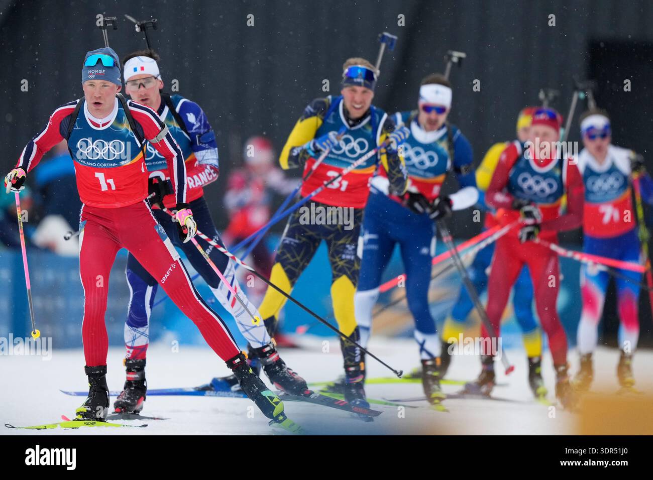 Martin Uldal, of Norway, left, competes in the men's 4x7.5-kilometer ...