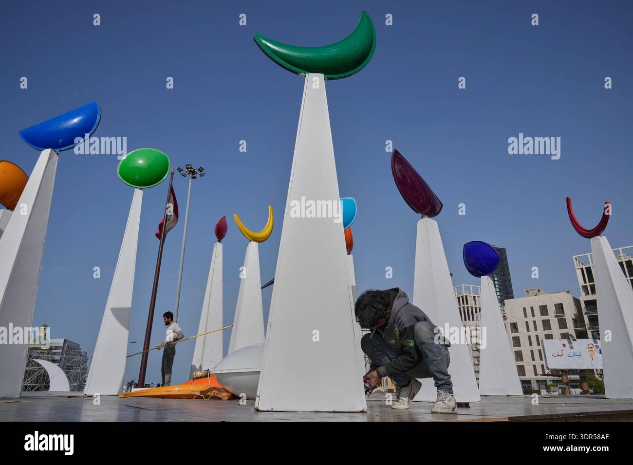 A worker sets decorations in preparation for the upcoming Muslim holy ...