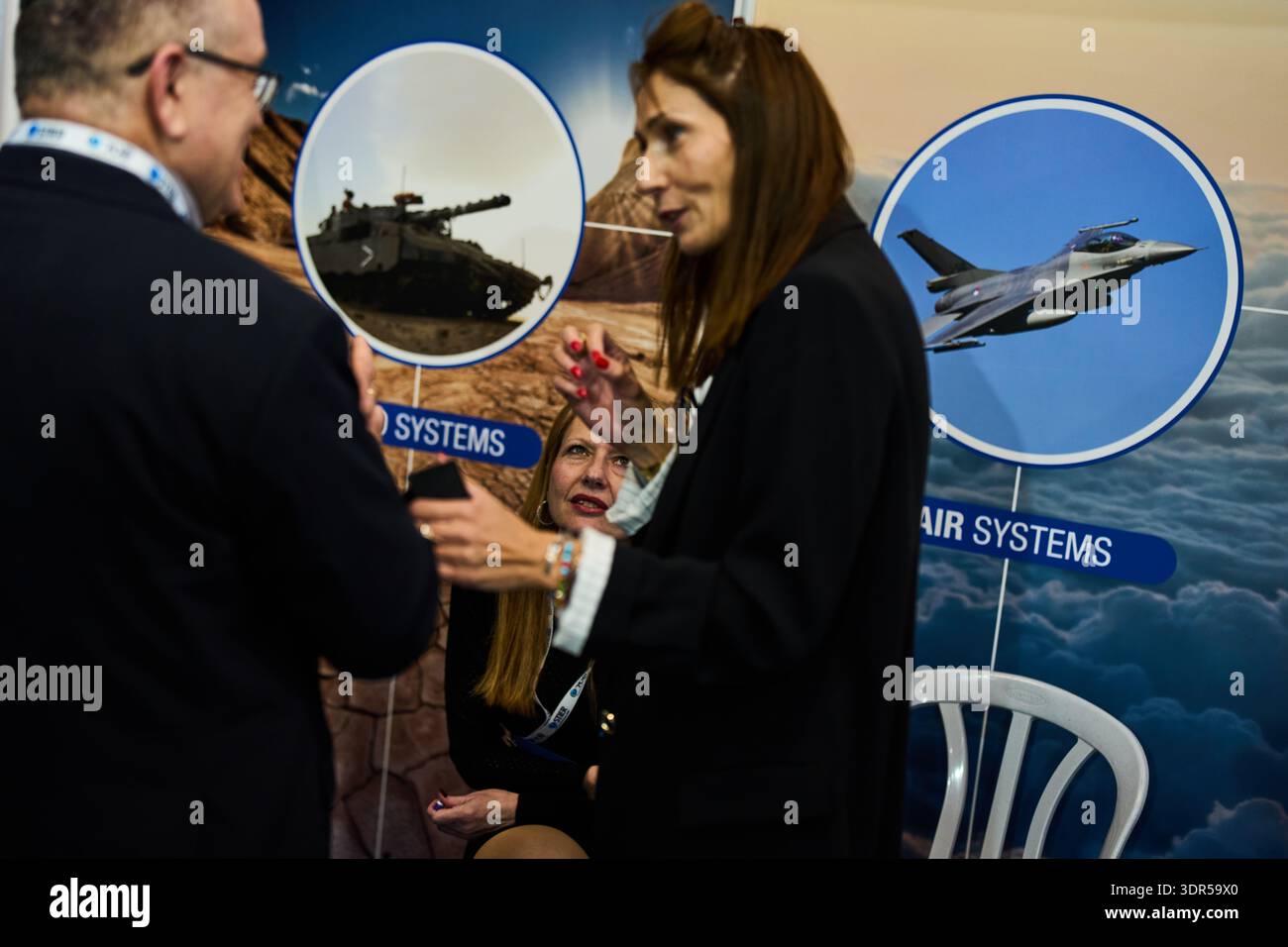 Visitors attend a defense industry exhibition in Tel Aviv, Israel ...