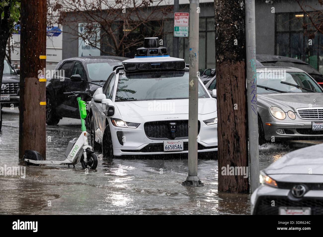 Self-driving Waymo electric vehicles stop and shut down at rain-soaked ...