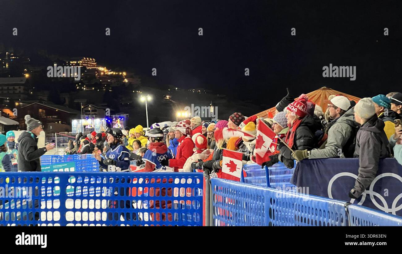 Livigno, Italy - February 15, 2026: Spectators with national flags ...