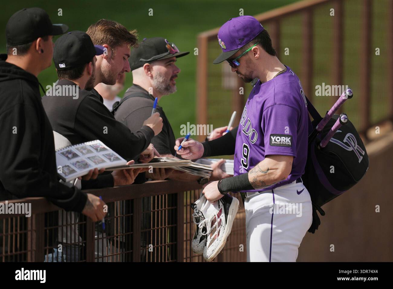 Colorado Rockies' Brenton Doyle signs autographs during spring training ...
