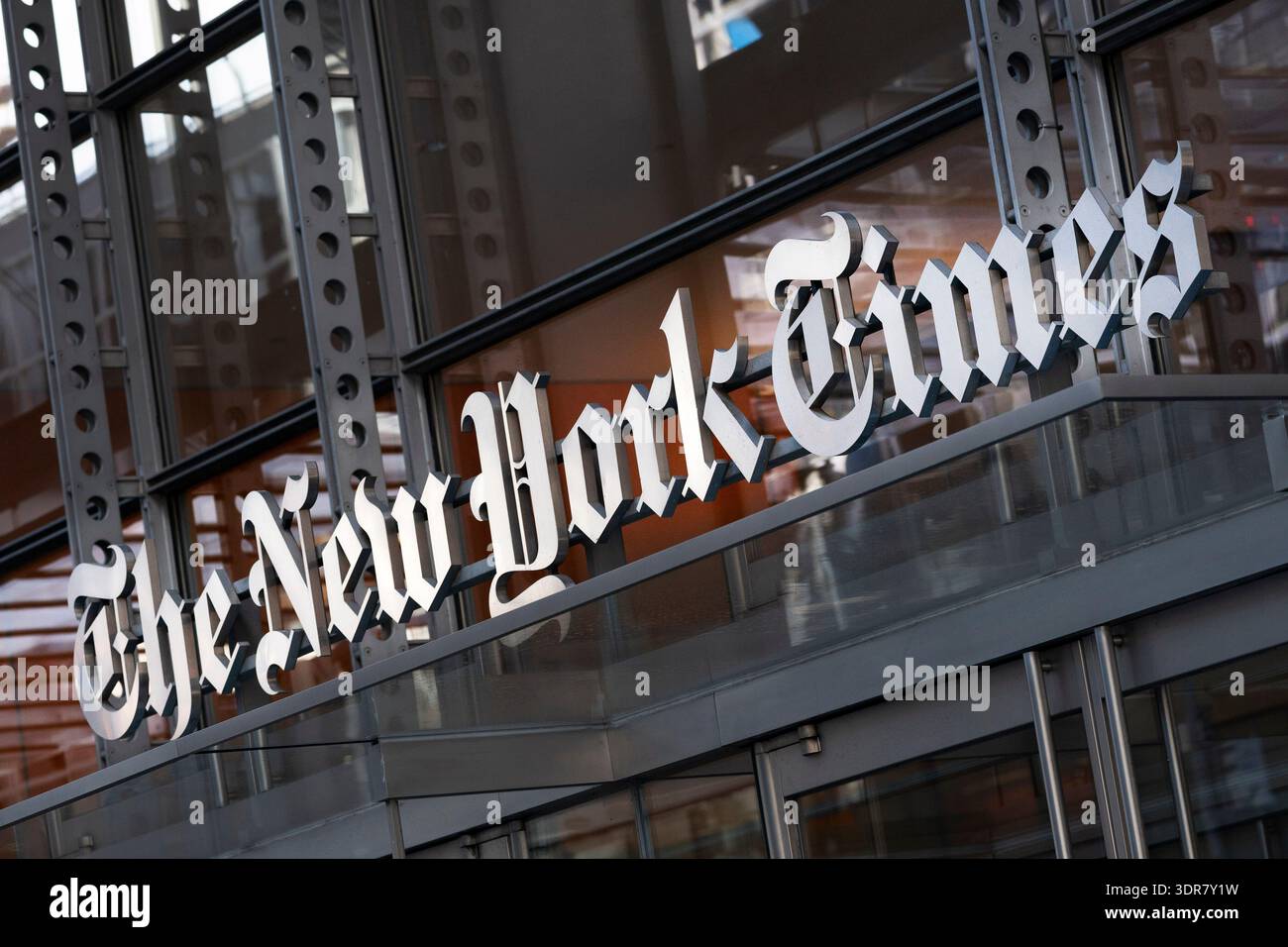 FILE - A sign for The New York Times is displayed above the entrance to ...