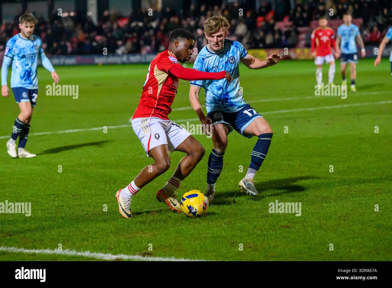 Tom Davies of Newport County tackles Kelly Nmai of Salford City FC ...