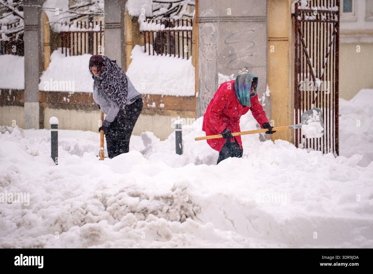Women shovel snow outside a clinic after a blizzard in Bucharest ...