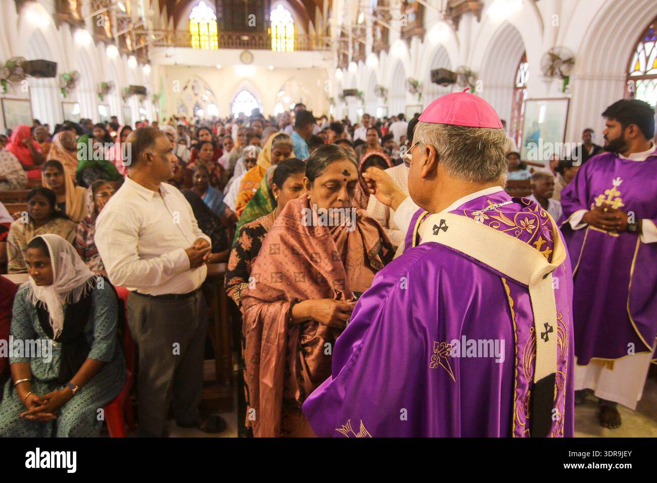 Chennai, India. 18th Feb, 2026. Catholic devotees offer prayers during ...