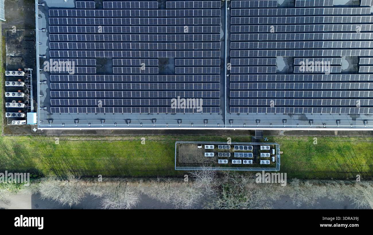 Aerial view of a building adorned with a vast array of solar panels ...