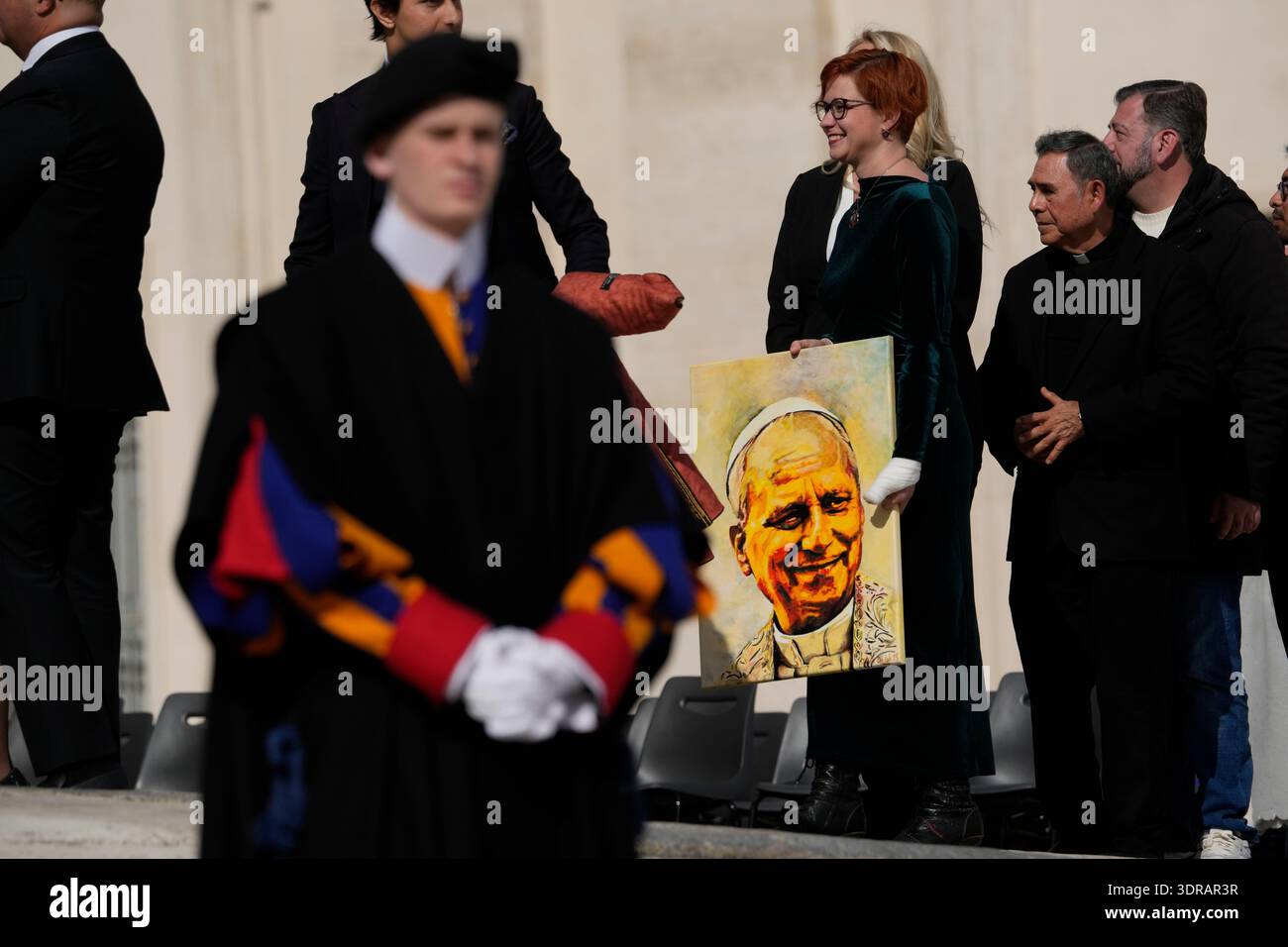 A woman prepares to meet Pope Leo XIV in St. Peter's Square at the ...