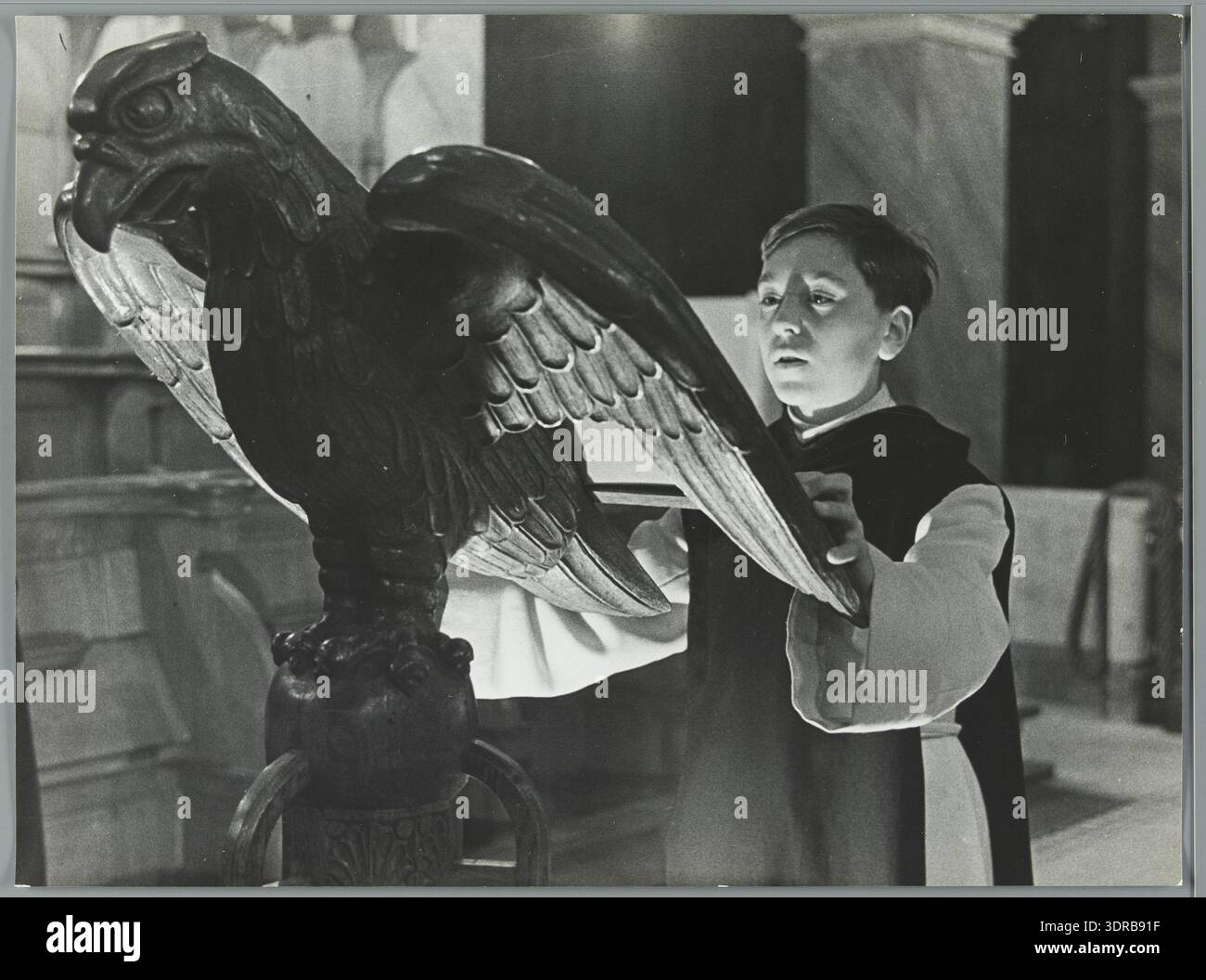 This 1935 photograph depicts a boy in religious attire standing hi-res ...