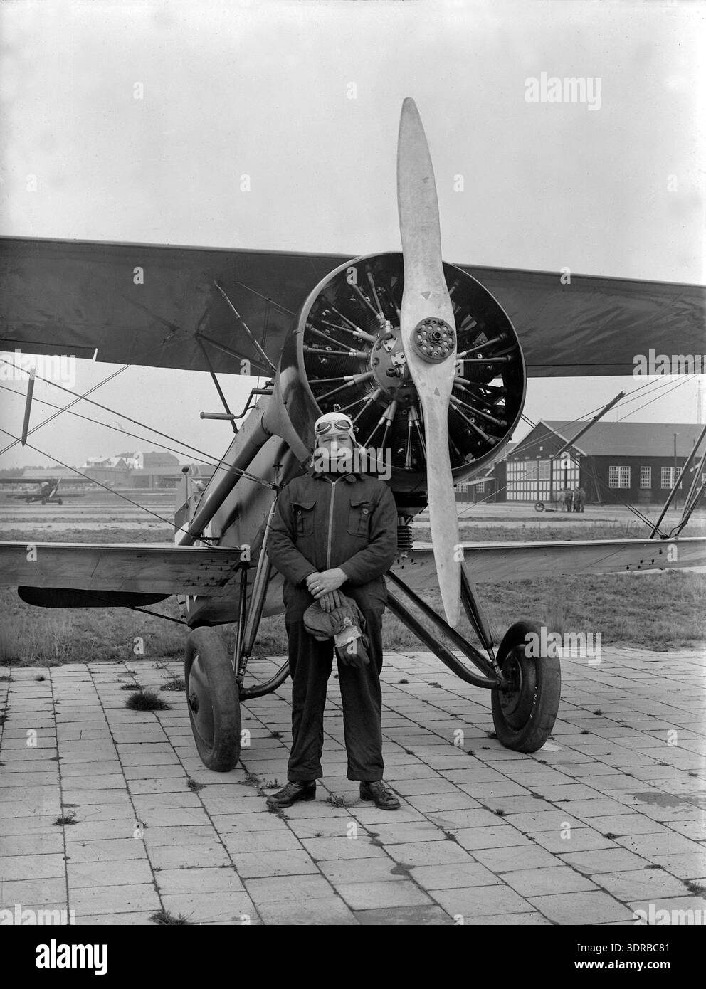 This photograph depicts a Dutch Air Force pilot wearing a flight suit ...