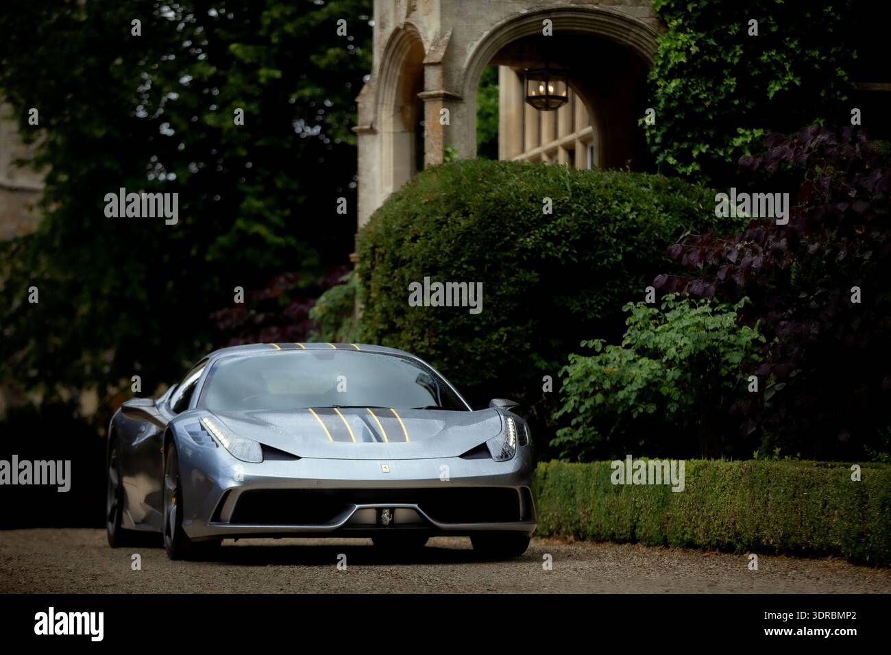 Grey Ferrari 458 speciale supercar parked beneath a historic stone ...