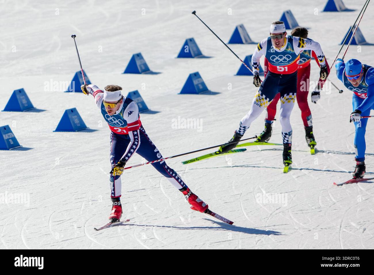 Ben Ogden, of the United States, left, competes in the cross-country ...