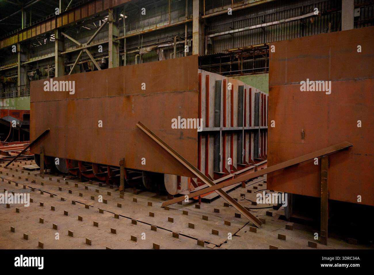 Massive steel sections of the ship's hull on the assembly yard. The ...