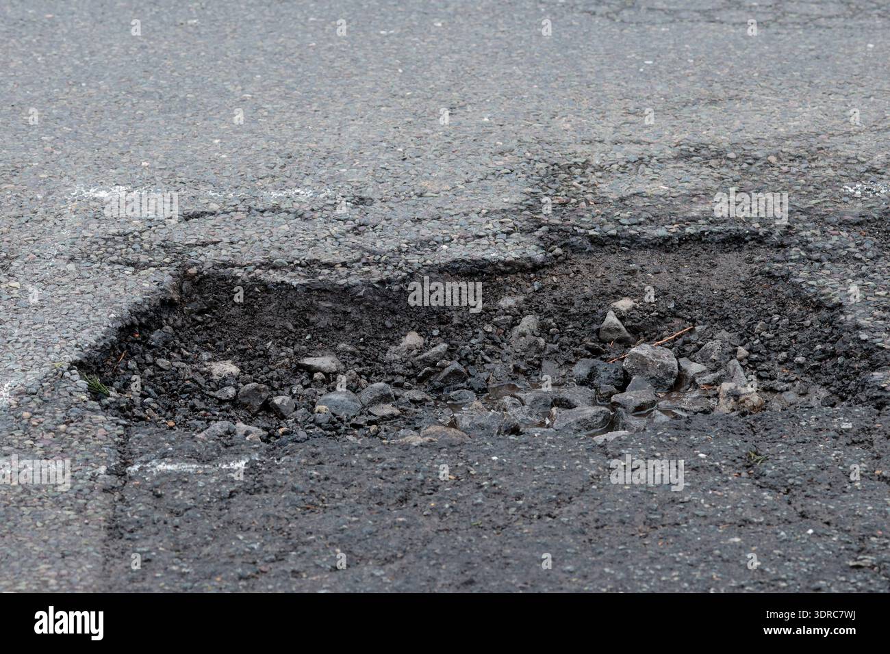 Loose tarmac rubble in bottom of large pothole hi-res stock photography ...