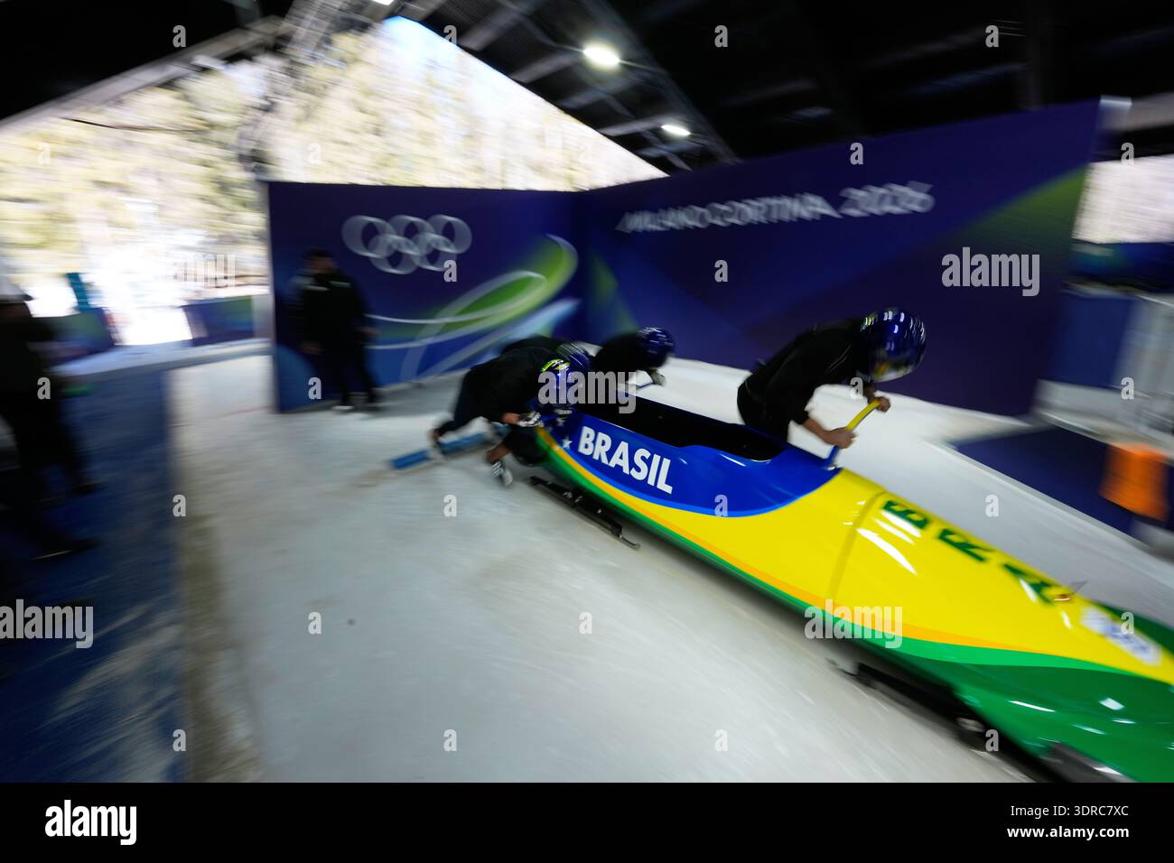 Brazil's Edson Luques Bindilatti, right, starts for a four man bobsled ...