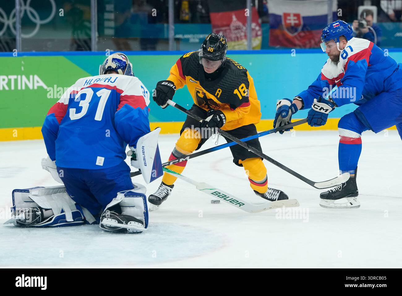 Germany's Tim Stutzle (18) challenges with Slovakia's Samuel Hlavaj (31 ...