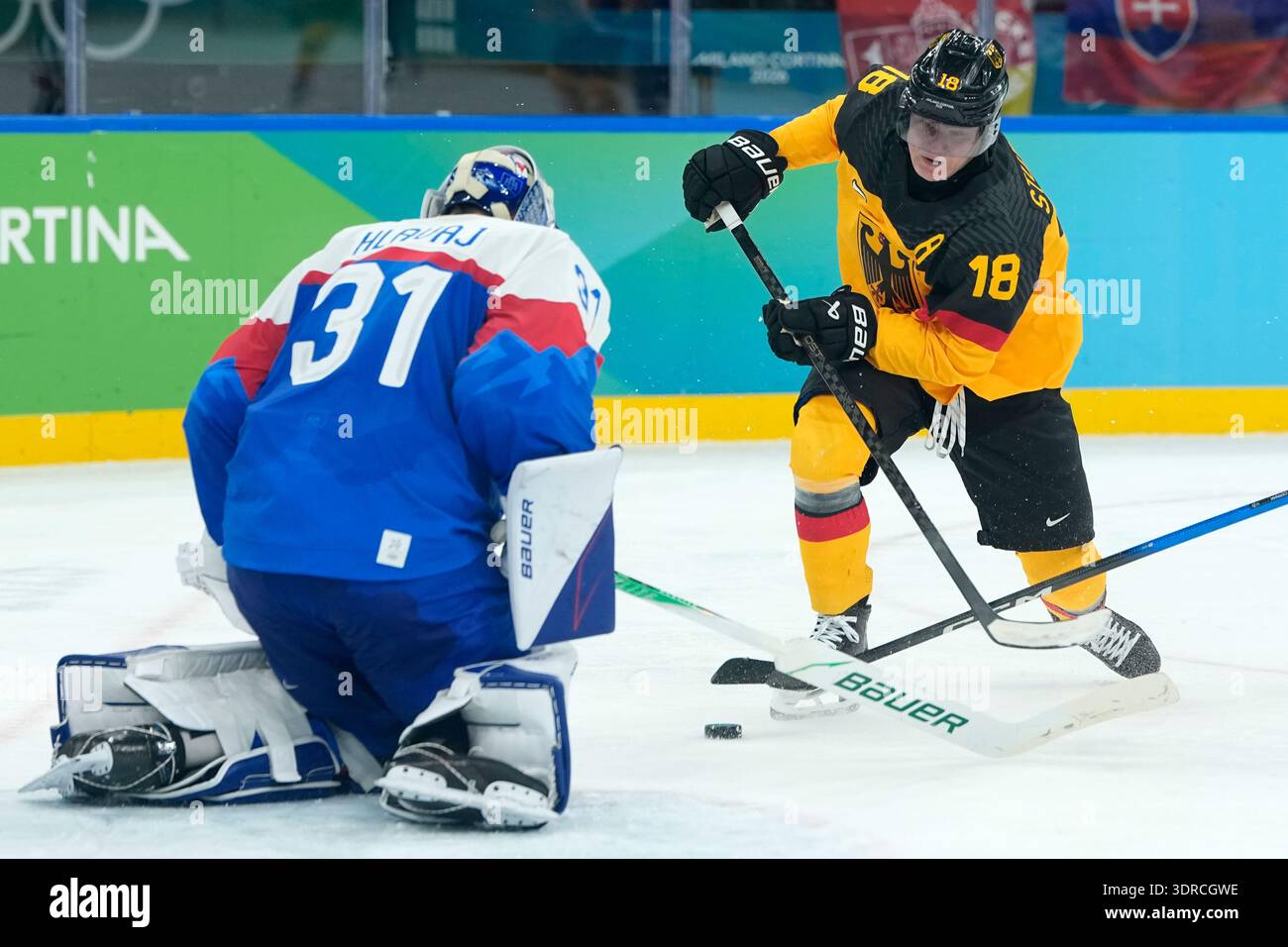 Germany's Tim Stutzle (18) challenges with Slovakia's Samuel Hlavaj (31 ...