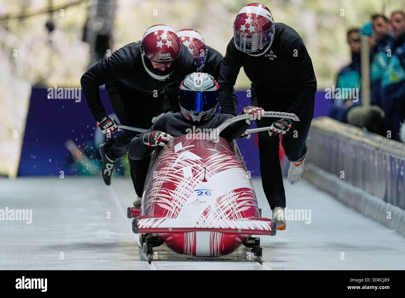 Latvia's Jekabs Kalenda, front, starts for a four man bobsled training ...