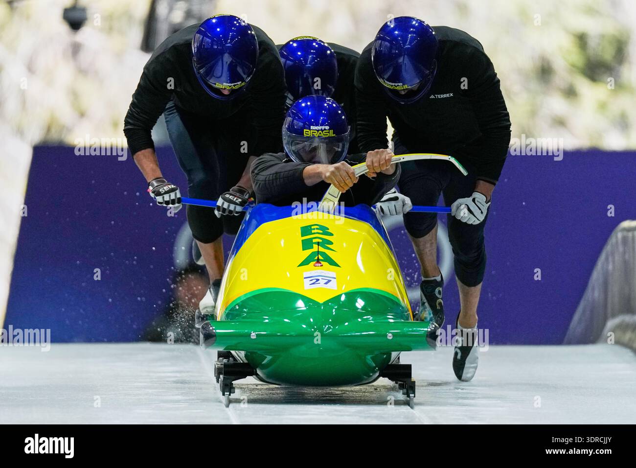 Brazil's Edson Luques Bindilatti, front, starts for a four man bobsled ...