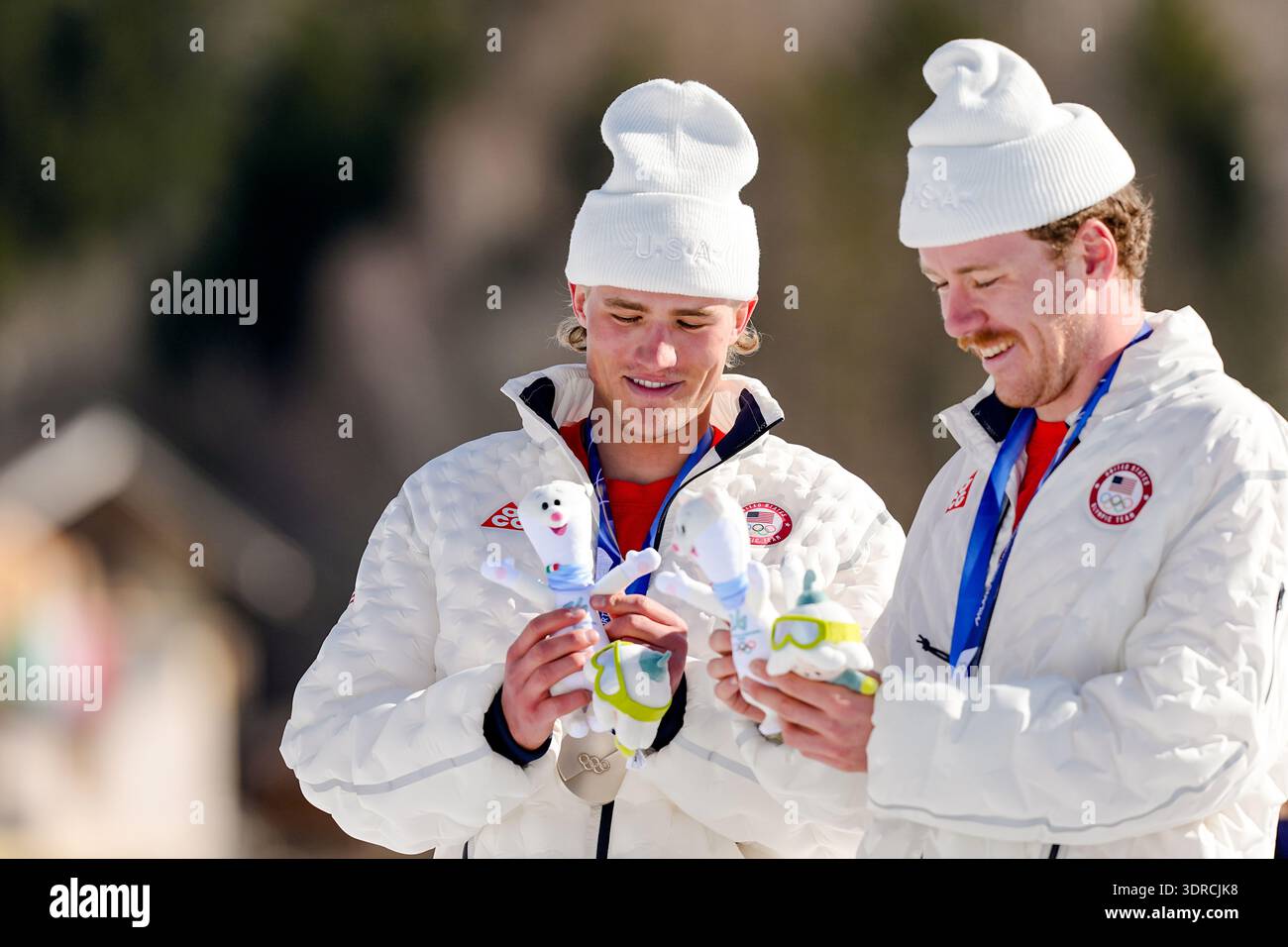 Ben Ogden and Gus Schumacher, of the United States, stand on the podium ...