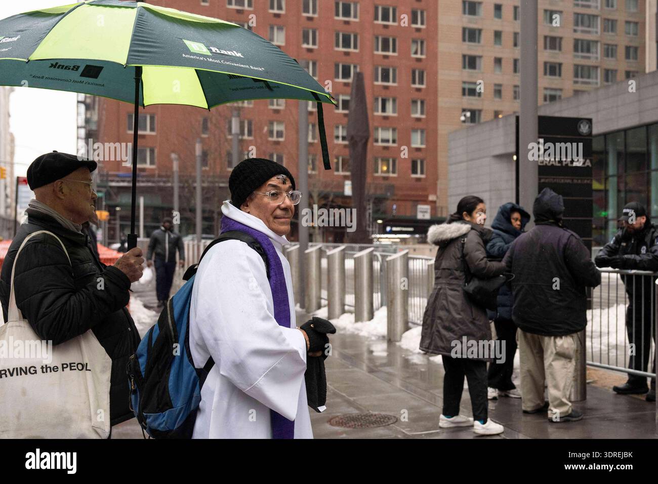 Father Fabian Arias waits for a devotee to place an ash cross on the ...