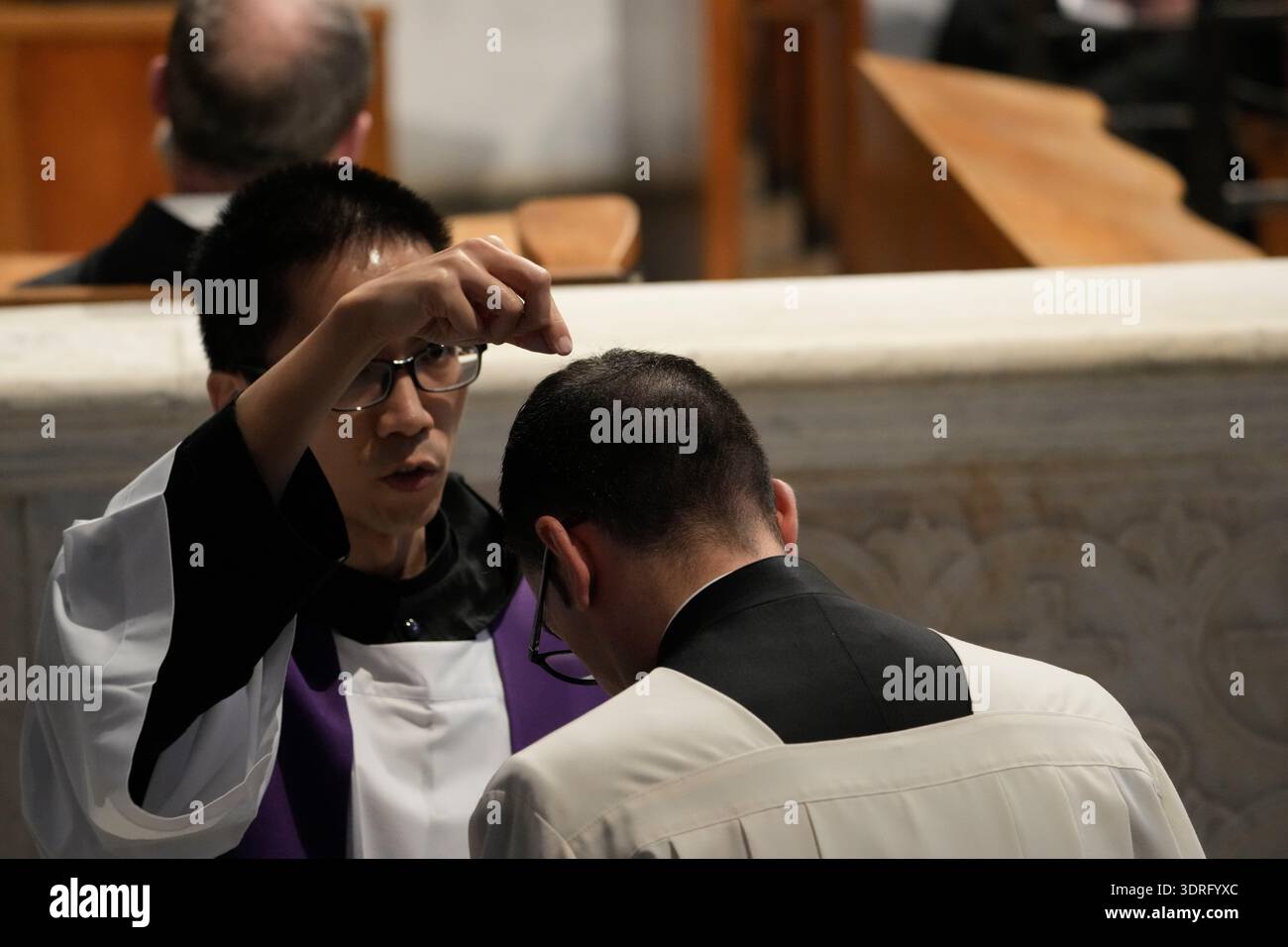 Priests asperge the ashes during Ash Wednesday Mass presided over by ...